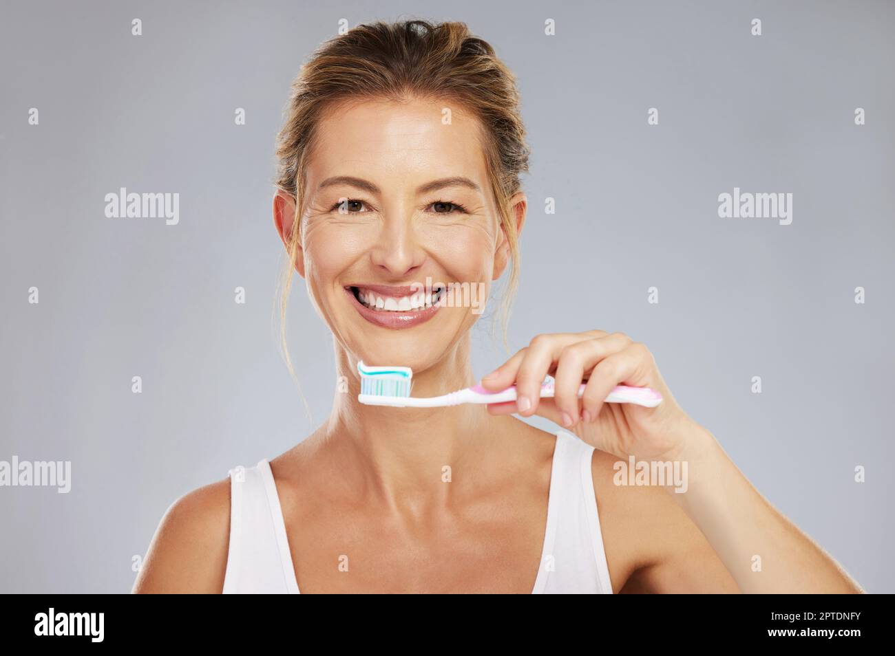 Teeth, dental and oral hygiene with a woman brushing using a toothbrush ...