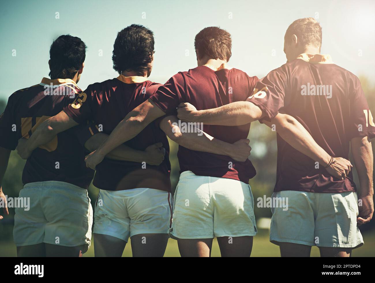 Getting ready for the scrum. Rearview shot of a young rugby team lining ...