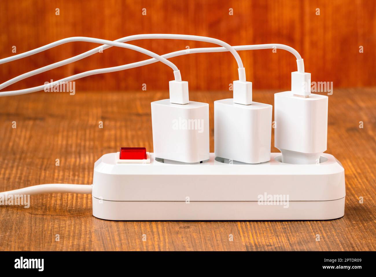 The electrical extension strip with connected white power plugs on the ...