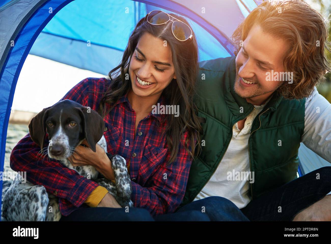 Hes the ultimate outdoors companion. an adventurous couple out camping ...