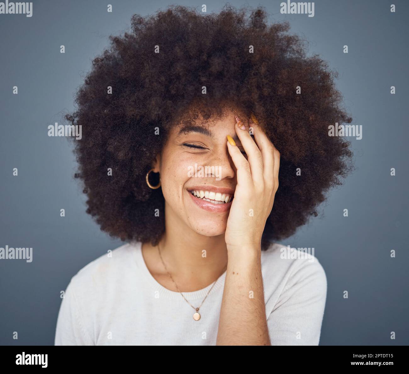 Comic, happy and black woman with a smile for memory, comedy and fashion against a grey studio ...