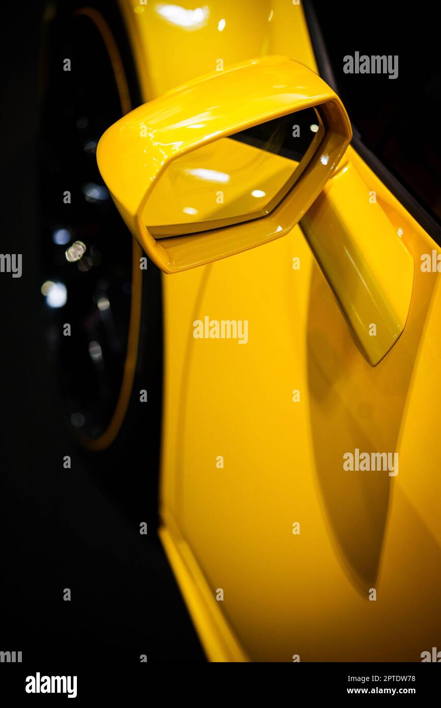 Image of a yellow sport car side rear view mirror Stock Photo - Alamy