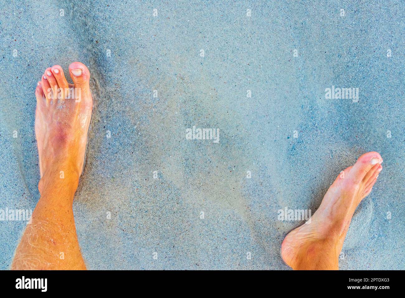 Walking barefoot on the beach sand by the water in Playa del Carmen ...