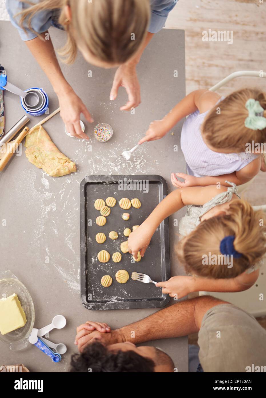 Baking, family and girl children learning to bake cookies in kitchen at ...