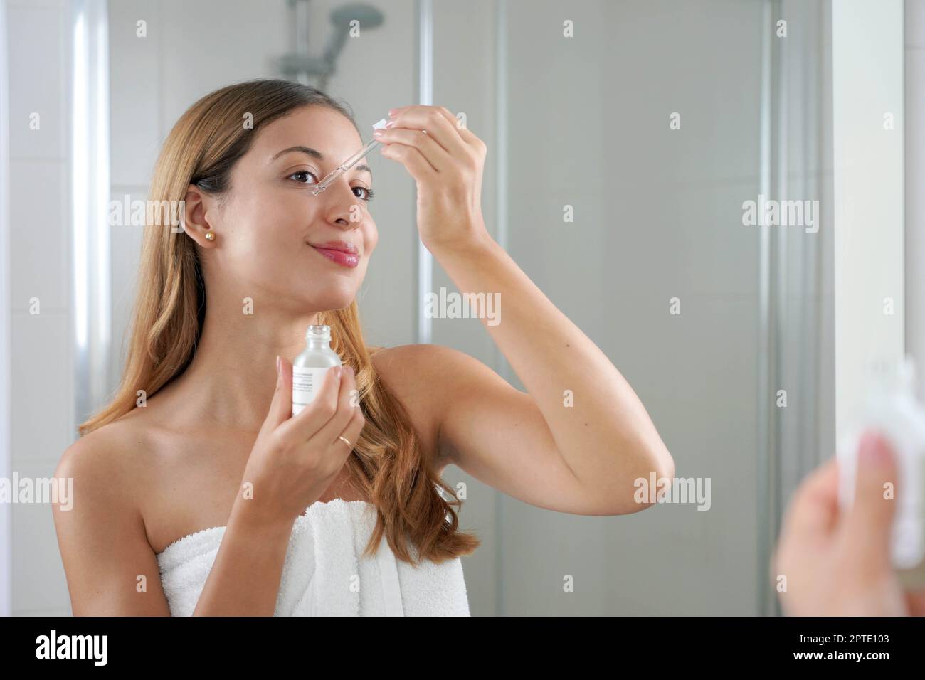 Beauty Woman Applying Hyaluronic Acid On The Face In The Bathroom Skin