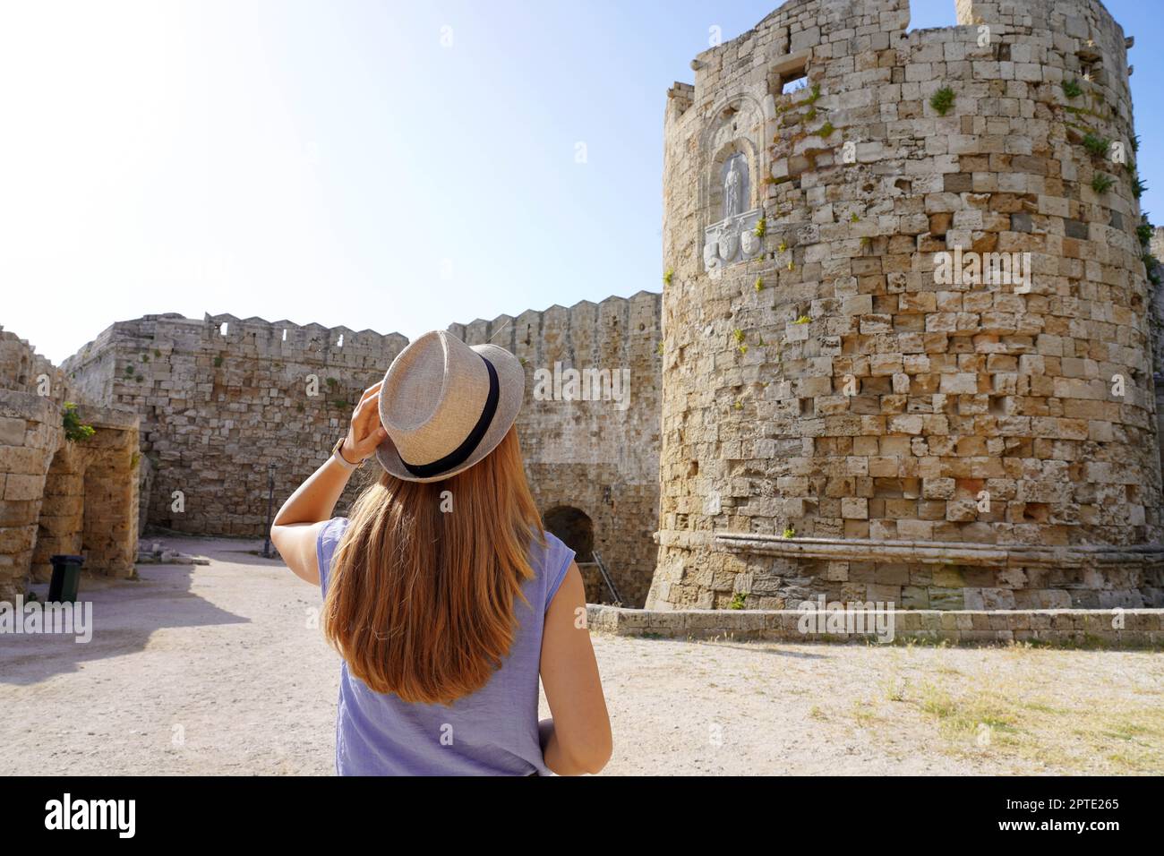 Holidays in Rhodes, Greece. Back view of traveler girl visiting Rhodes ...