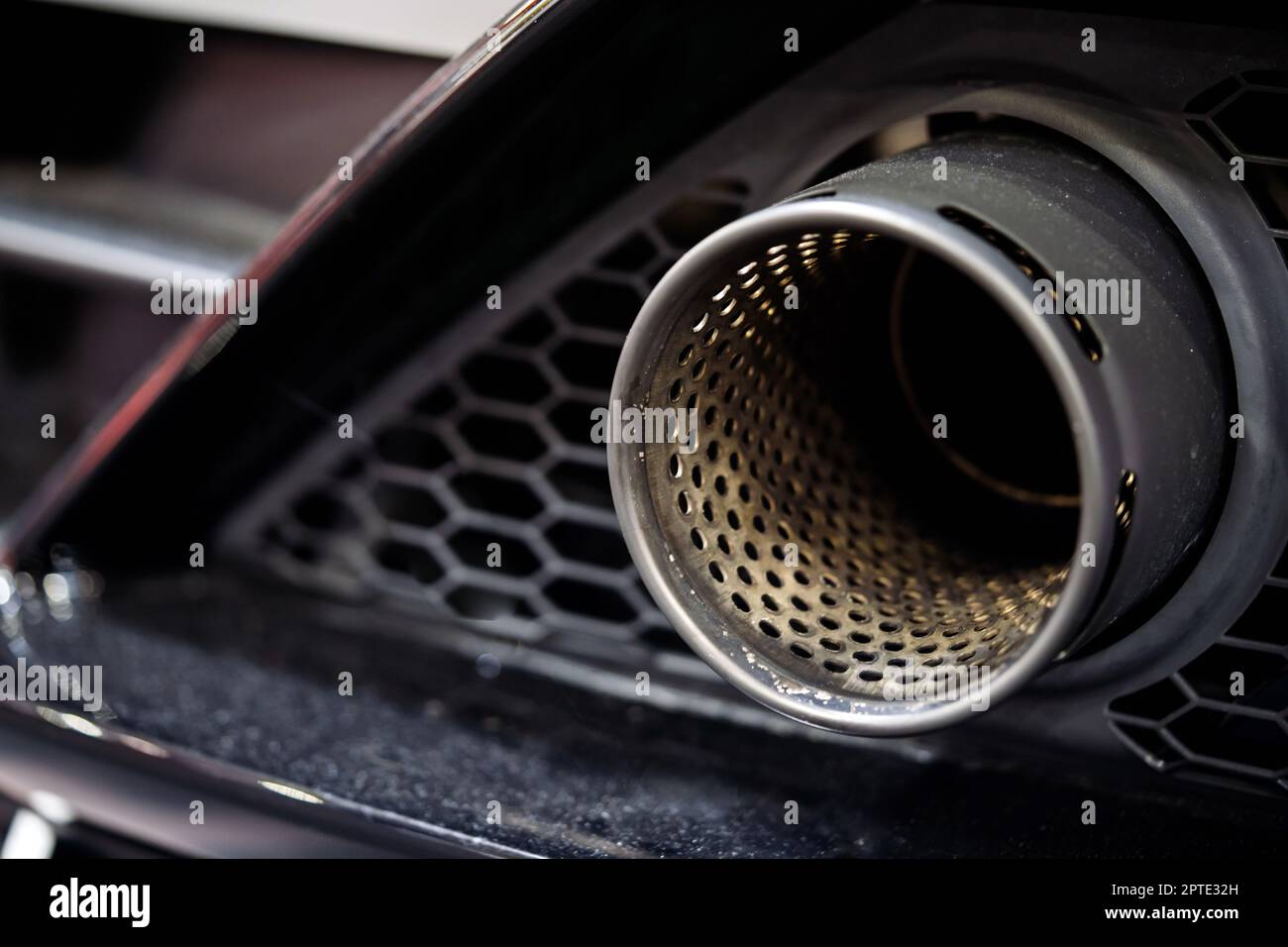 Close up shot of the rear exhaust pipe of a sports car Stock Photo - Alamy