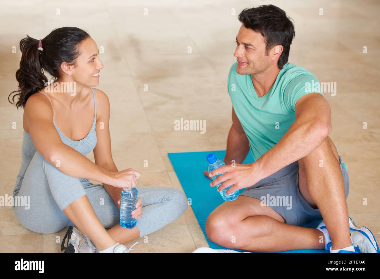 Taking a break between exercise routines. A young couple taking a break ...