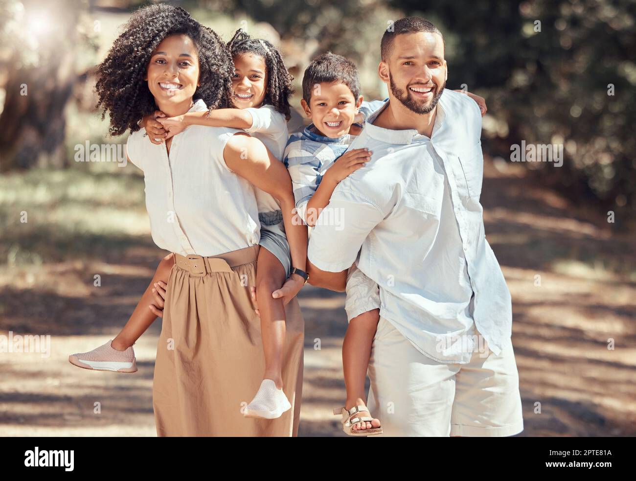 Portrait of happy family bonding in a park, having fun and being ...