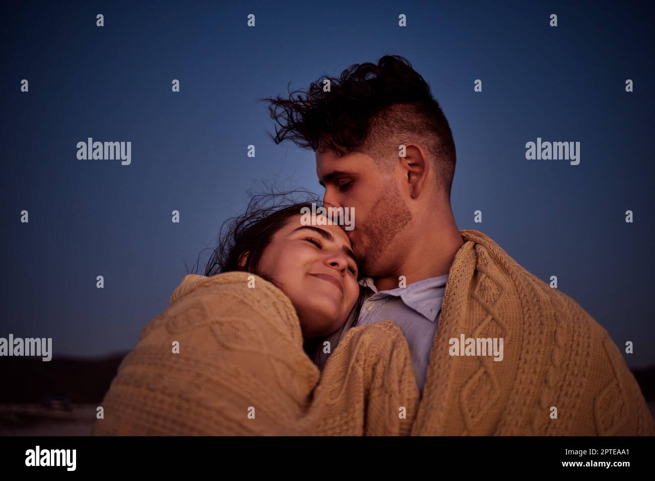 Sky, love and couple with blanket at night, enjoying the evening ...
