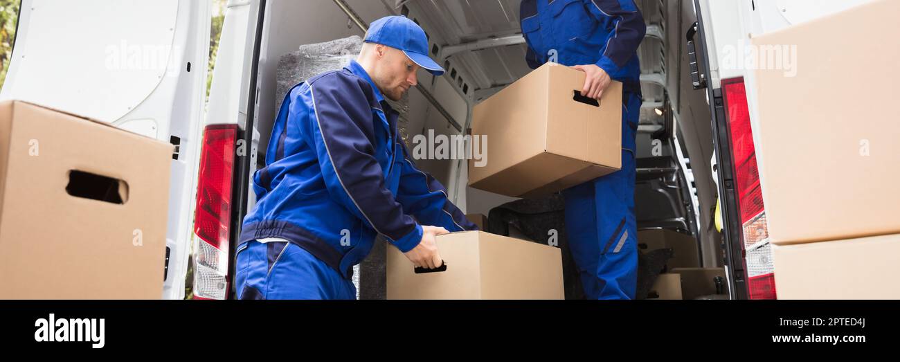 Van Movers Unloading Cardboard Boxes From Delivery Truck Stock Photo ...