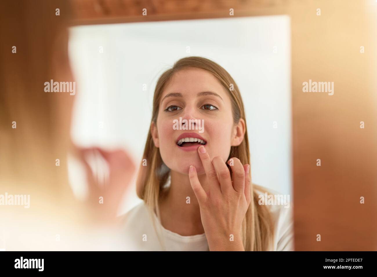 Touching Up Her Look A Young Woman Touching Up Her Lipstick In Front