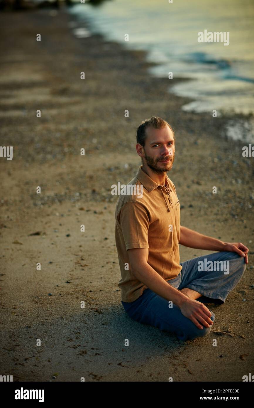 The ocean calms my soul. a man sitting in the lotus position during his ...