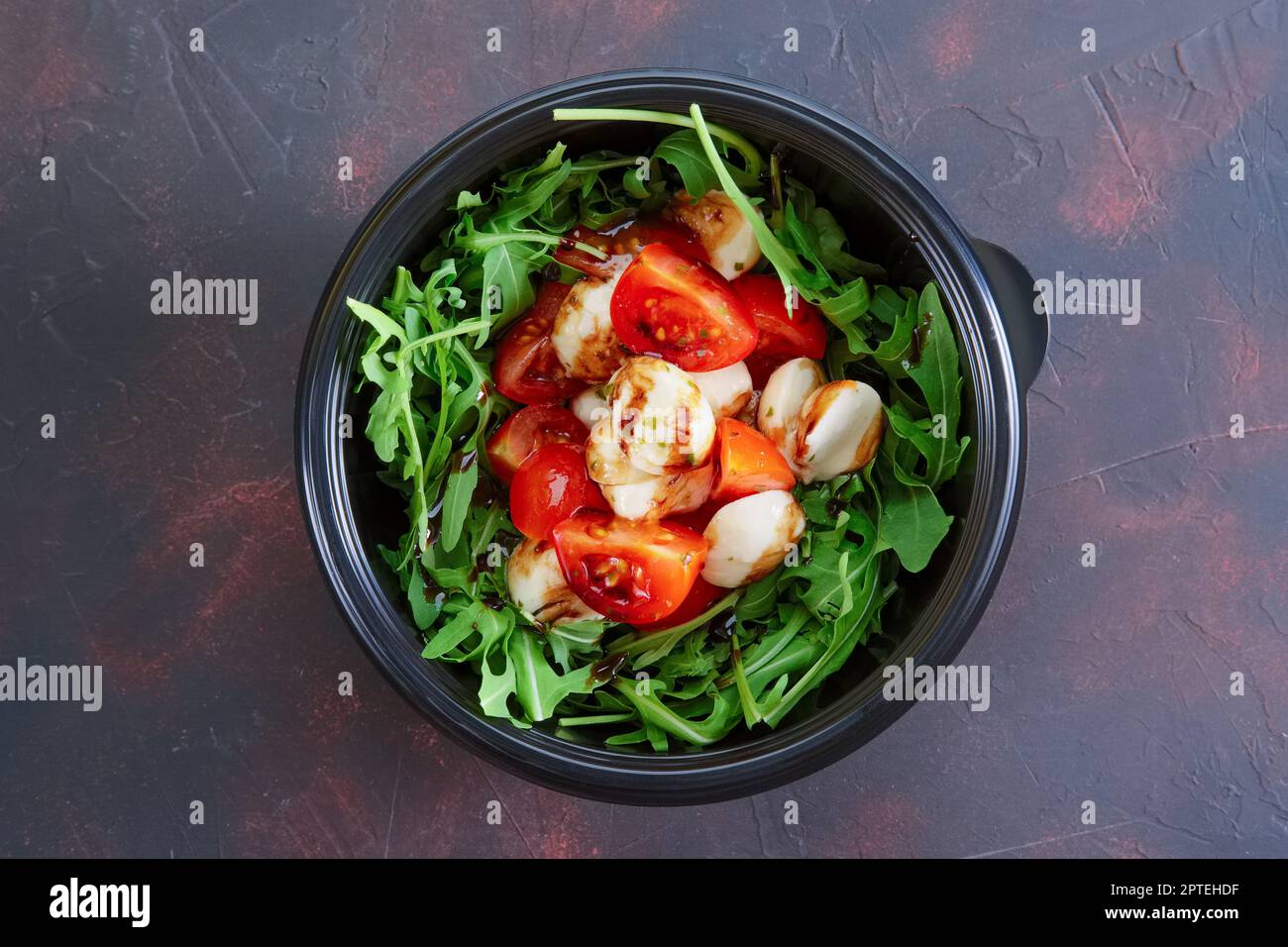 Salad with mozzarella, tomato and arugula in take away packaging Stock ...