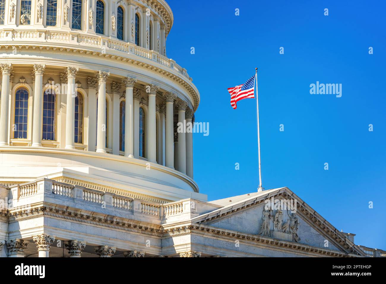 US Capitol and flag over blue sky, Washington DC Stock Photo - Alamy