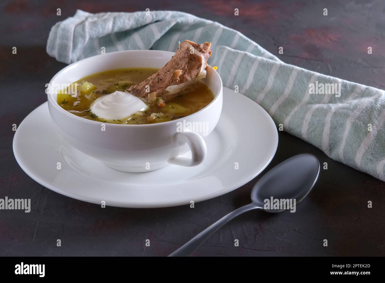 Beef bouillon with meat on a bone Stock Photo - Alamy