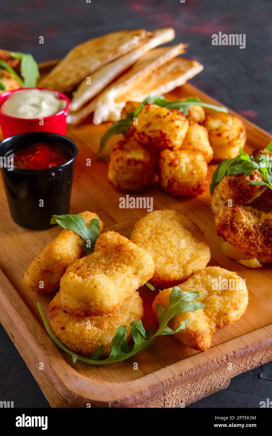 Wooden plate with snack for beer Stock Photo - Alamy