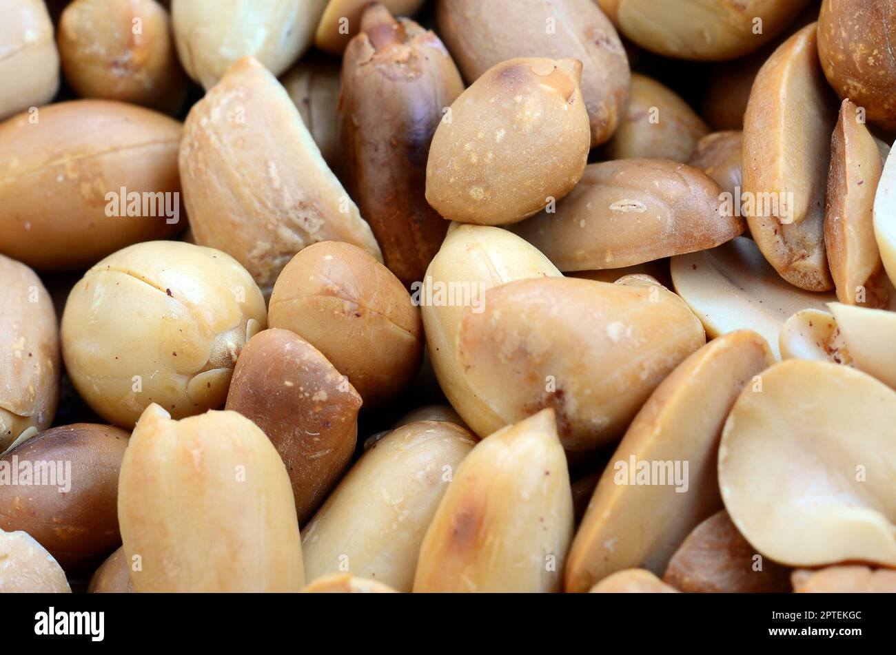 Peanut. A lot of small yellow nuts without peel. Background texture ...