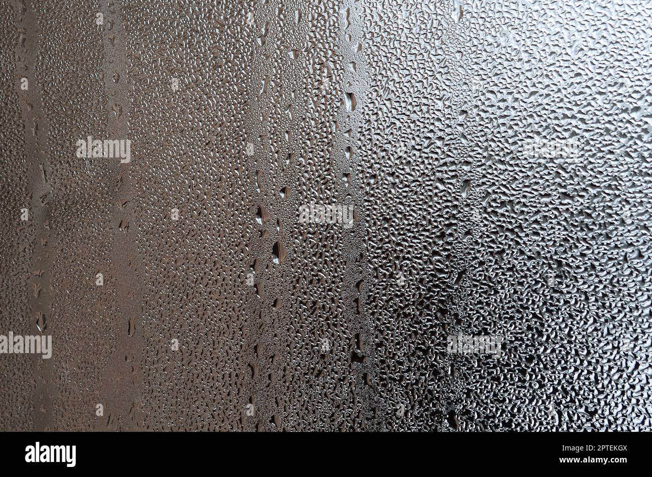 Texture of a drop of rain on a glass wet transparent background. Toned ...