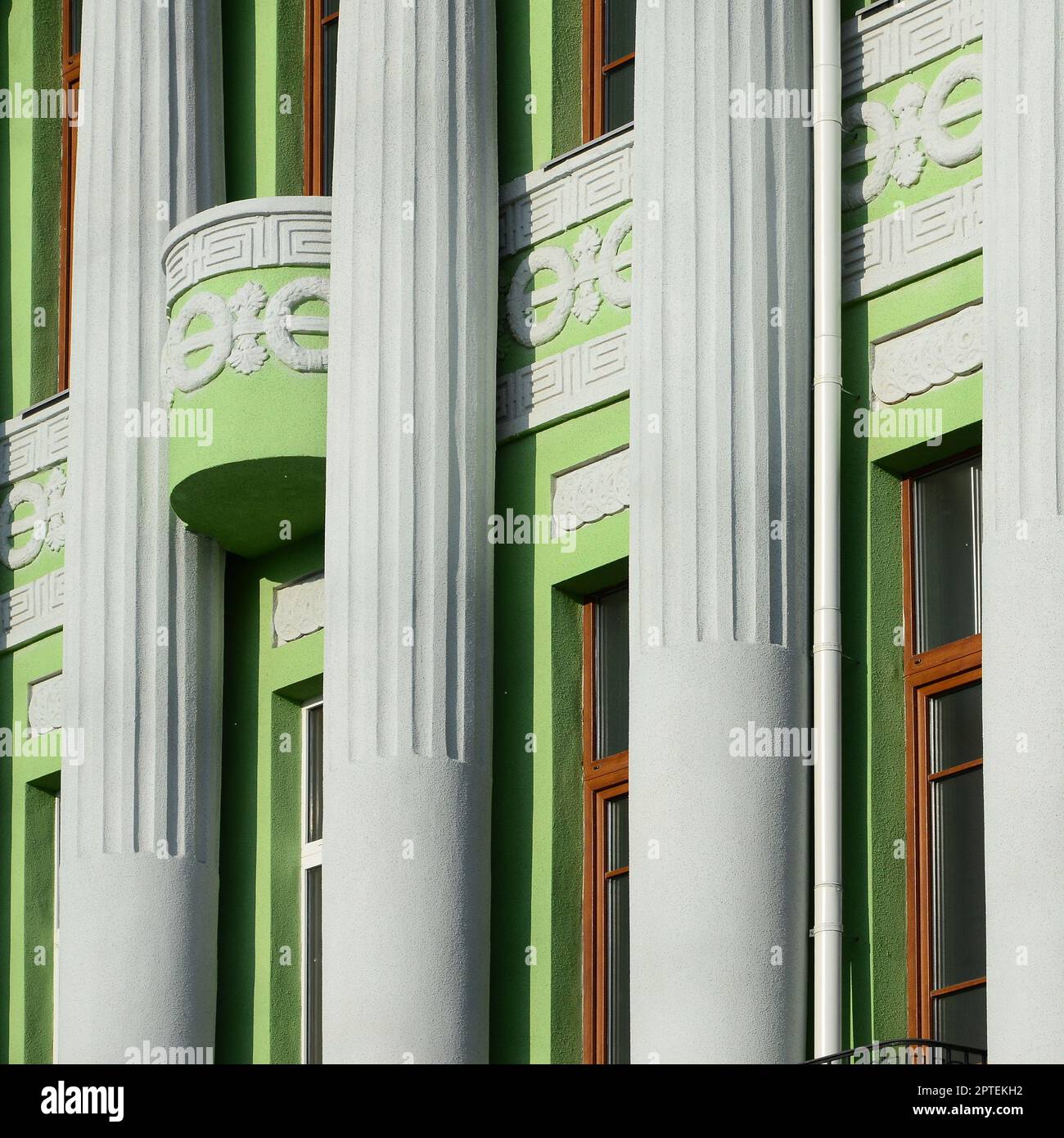 Restored old multi-storey building with antique columns, painted in ...