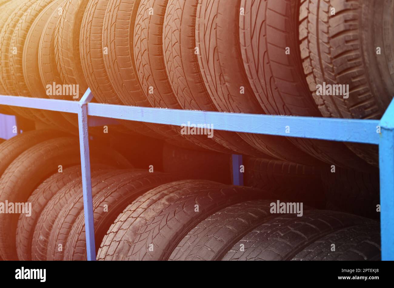 Rack with variety of car tires in automobile store. Many black tires ...