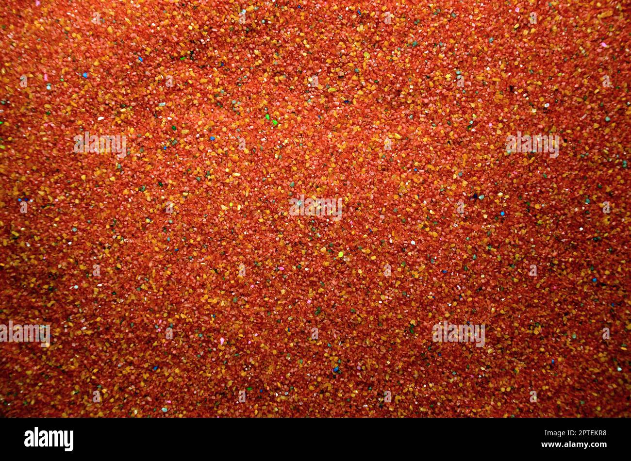Texture of a colored granular sand close up. Red grains Stock Photo - Alamy