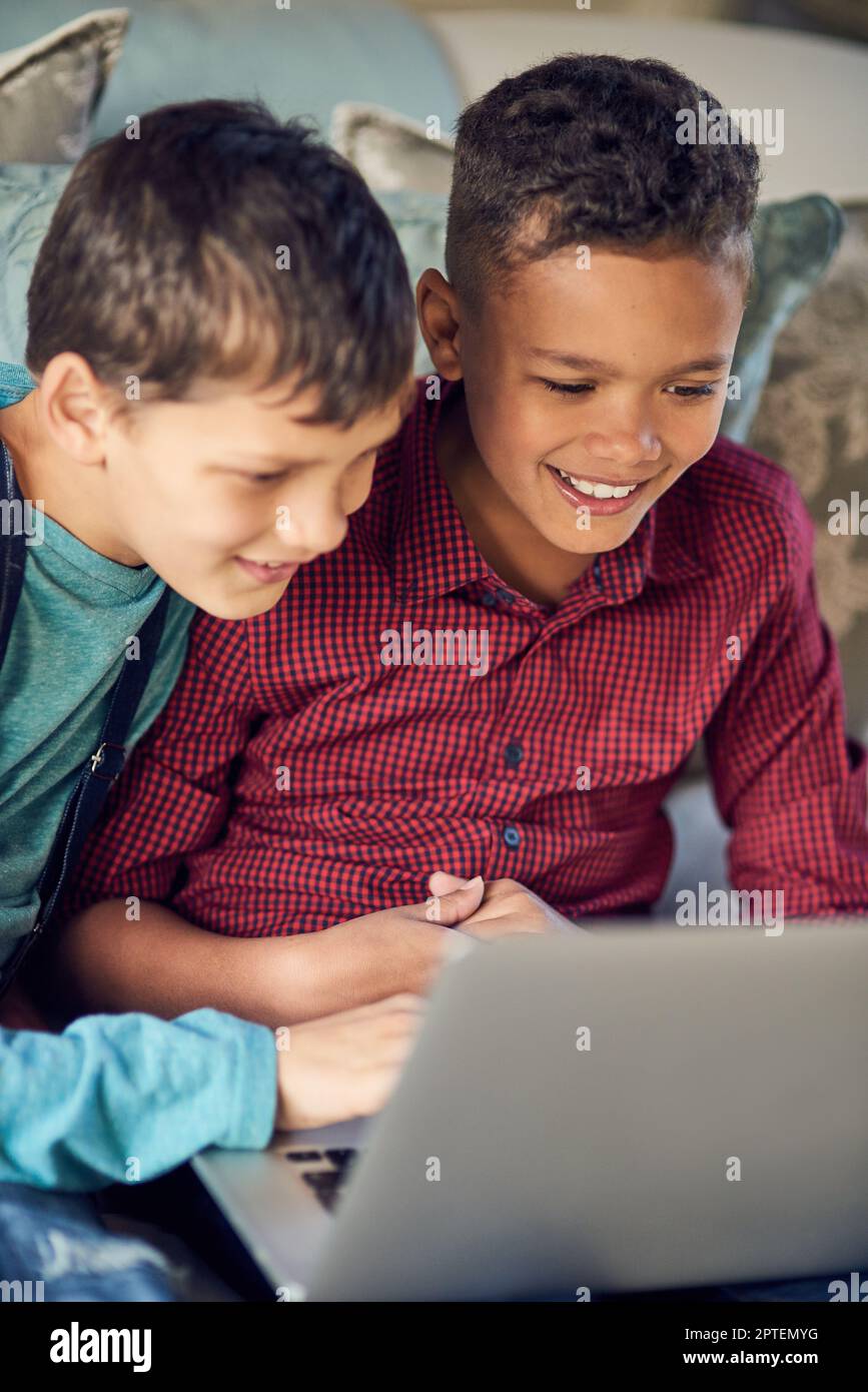 Two boys using laptop home hi-res stock photography and images - Alamy