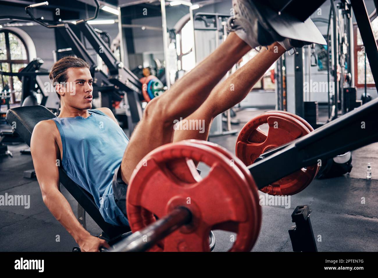 Fitness, gym and leg press, workout and weight with strong man ...