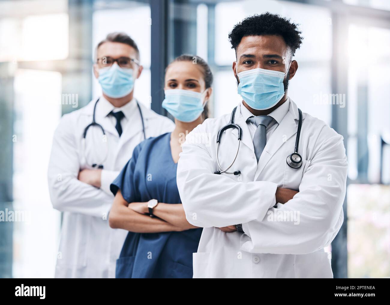Face mask, team and portrait of medical doctors standing in the hallway ...