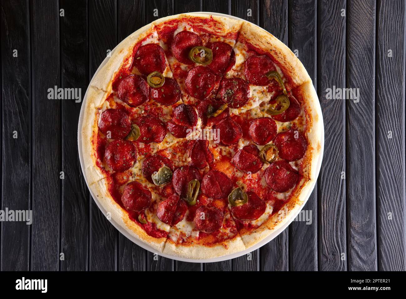 Hot pizza pepperoni with jalapeno pepper. Top view Stock Photo - Alamy