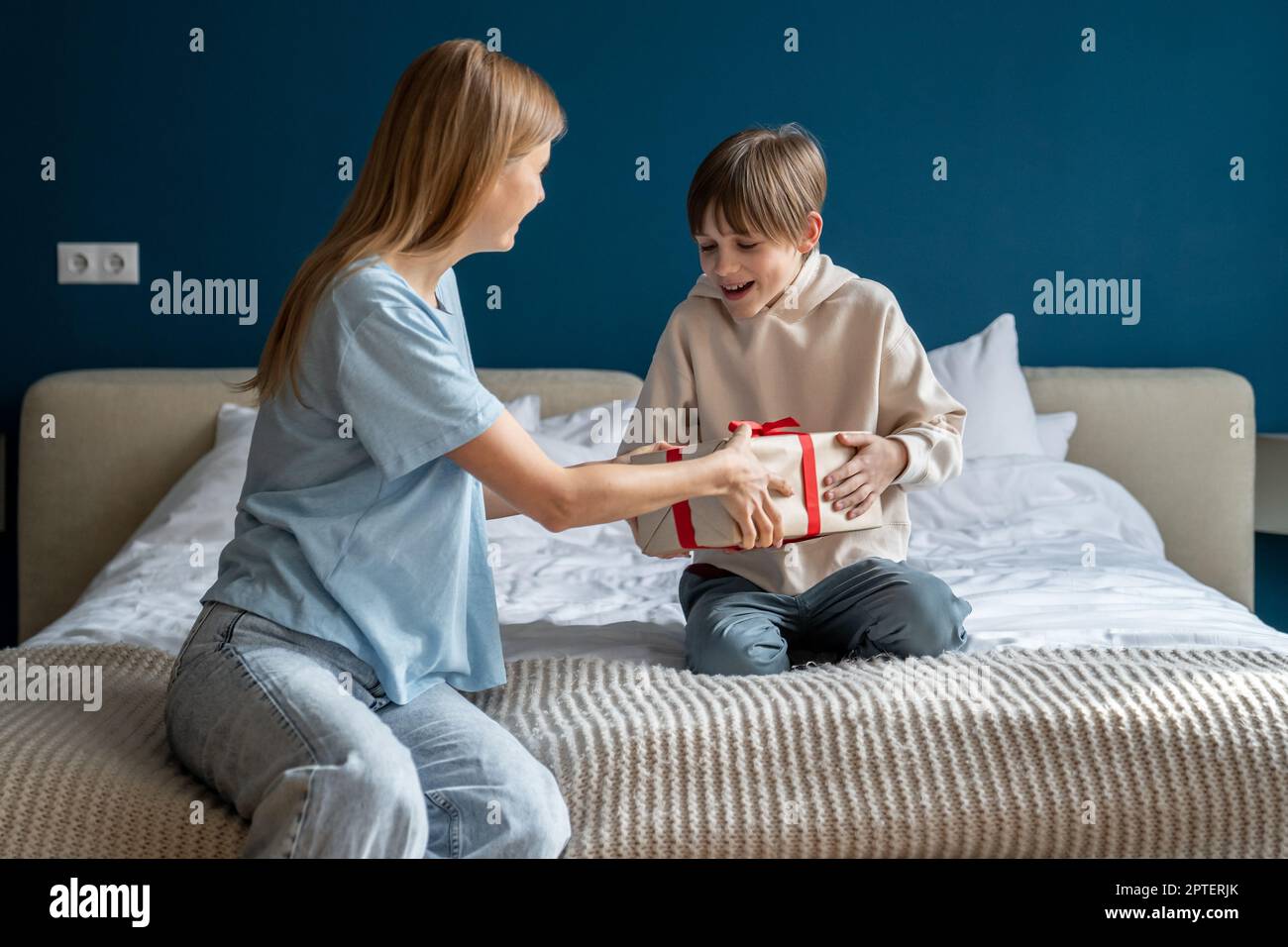 Excited overjoyed little boy child receiving unexpected birthday gift ...