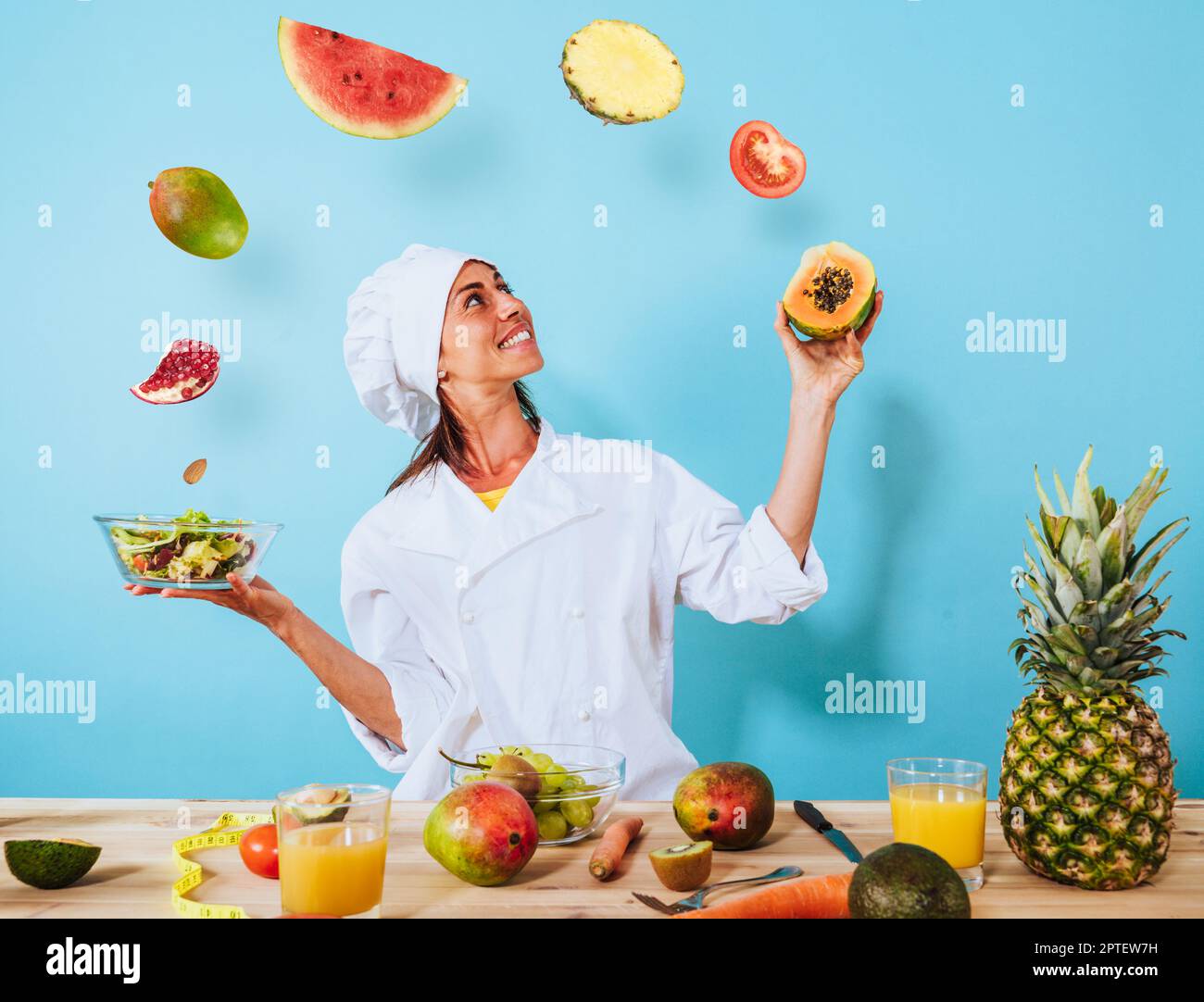 Woman chef prepares a new receipt with fresh fruits Stock Photo - Alamy