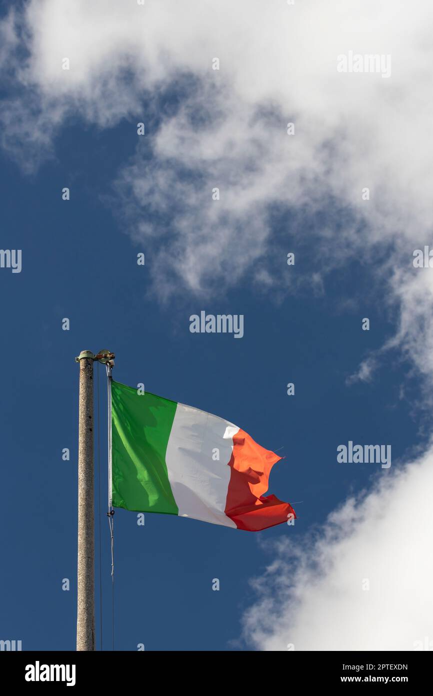 Italian flag blowing in the wind in the blue sky Stock Photo - Alamy