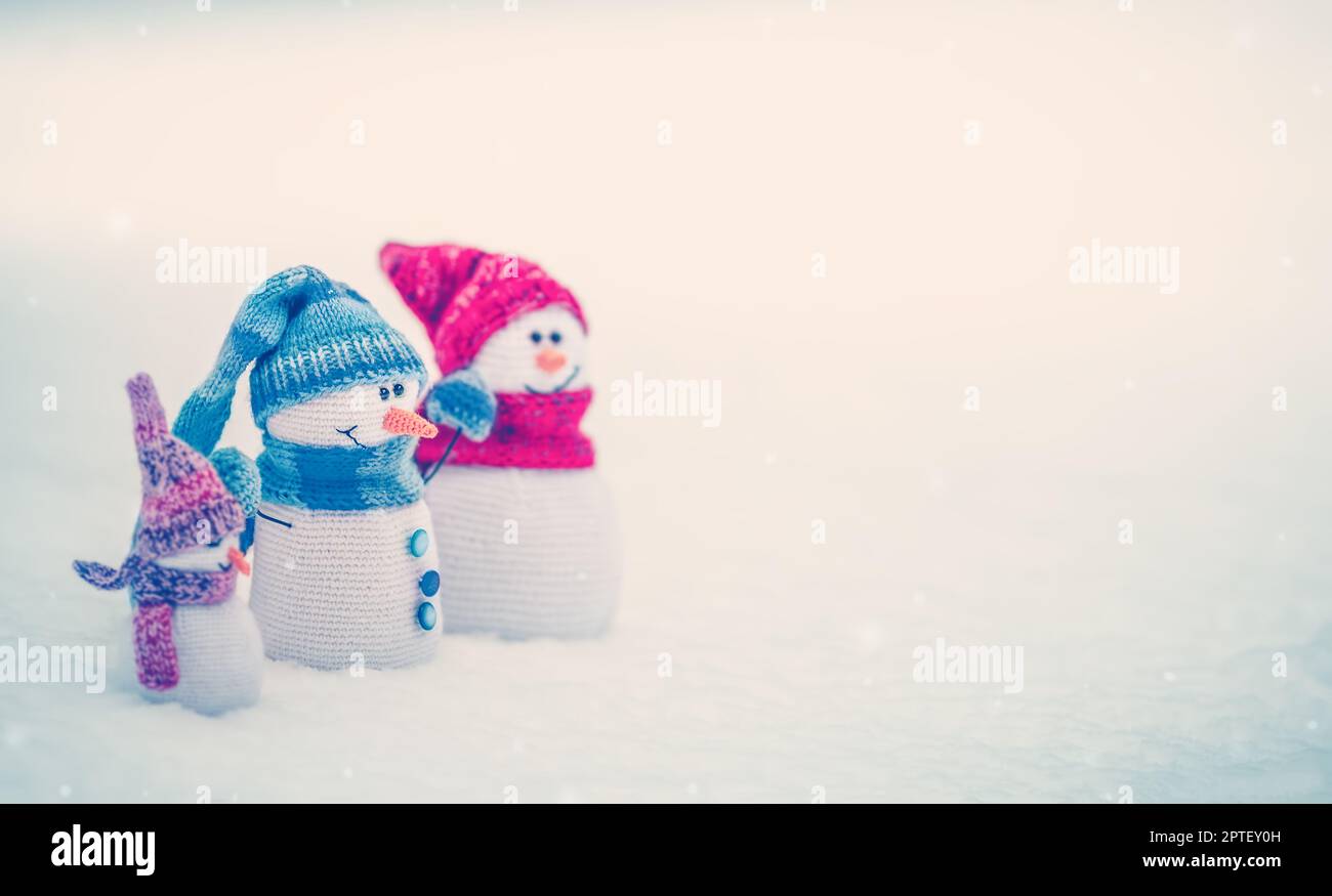 Little knitted snowmen on the white snow in nature. Concept of the ...