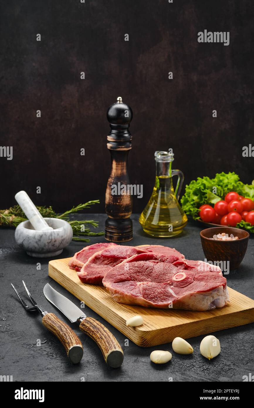 Lamb steaks with spice and knife and fork with horn handle (photo with ...