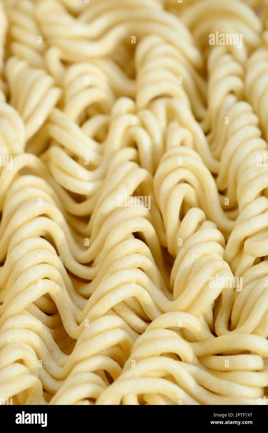 Close up view of yellow dry instant noodles. Chinese traditional food ...