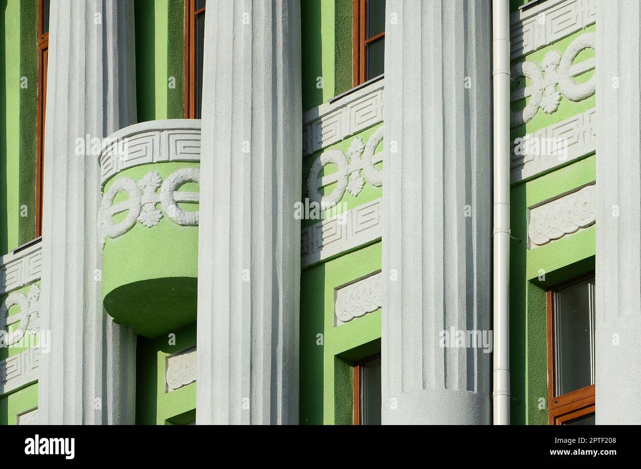 Restored old multi-storey building with antique columns, painted in ...