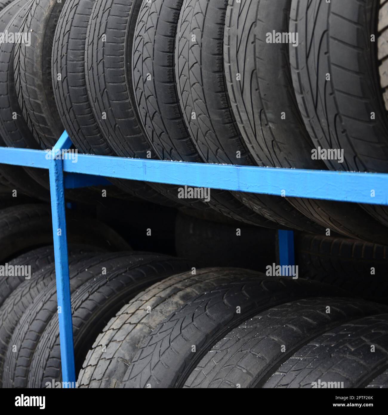 Rack with variety of car tires in automobile store. Many black tires ...