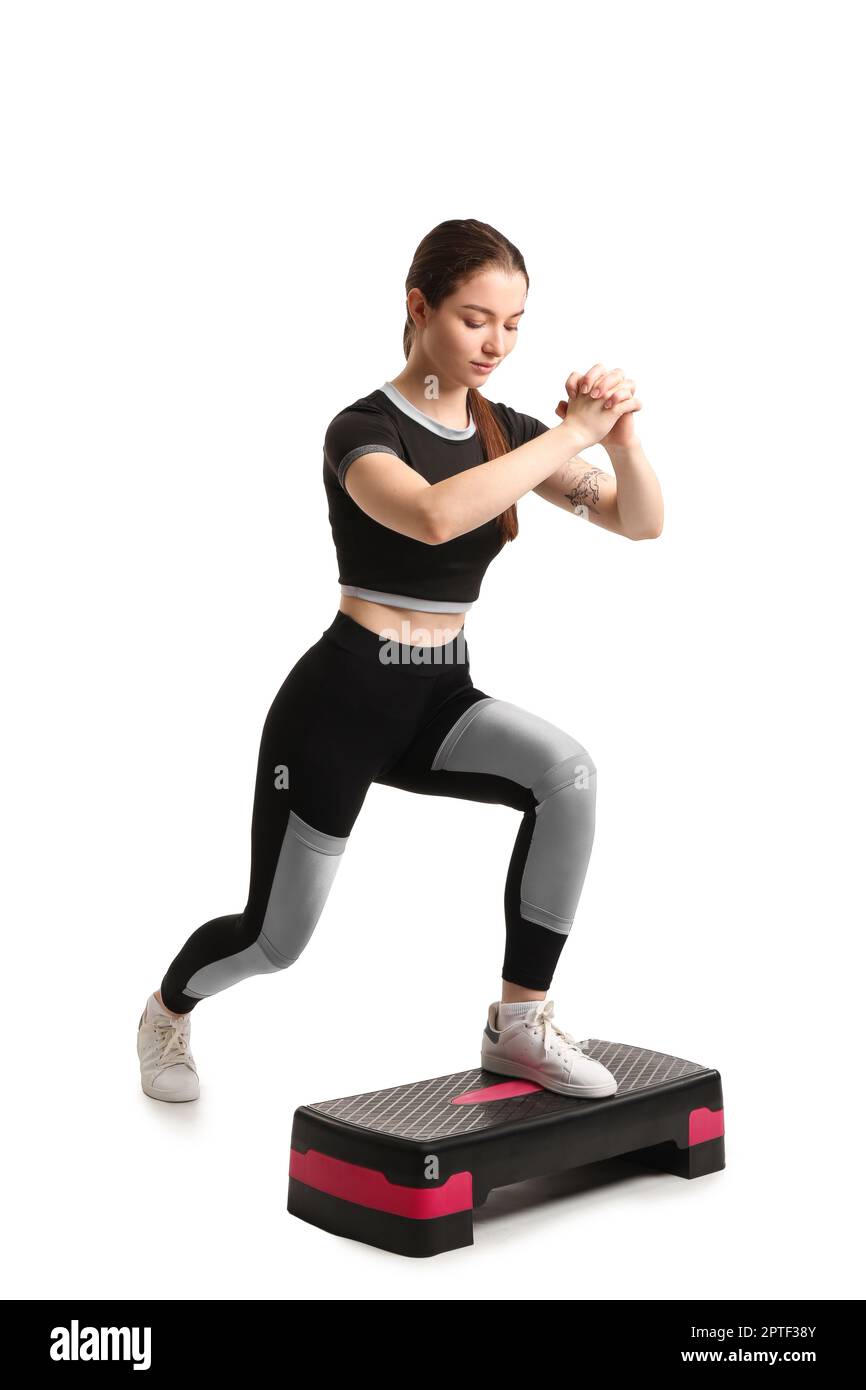 Sporty young woman training with stepper on white background Stock ...