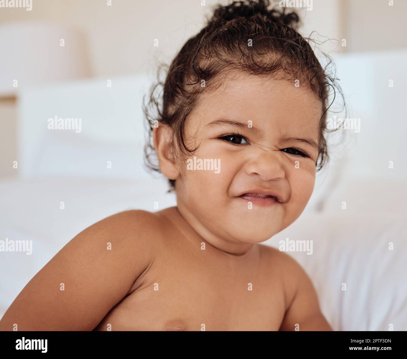 Baby, face and relax in bedroom for skincare morning routine in family ...