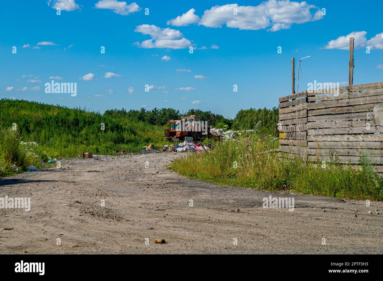 Tractor picking up garbage at a public dump. Industrial waste. Garbage ...