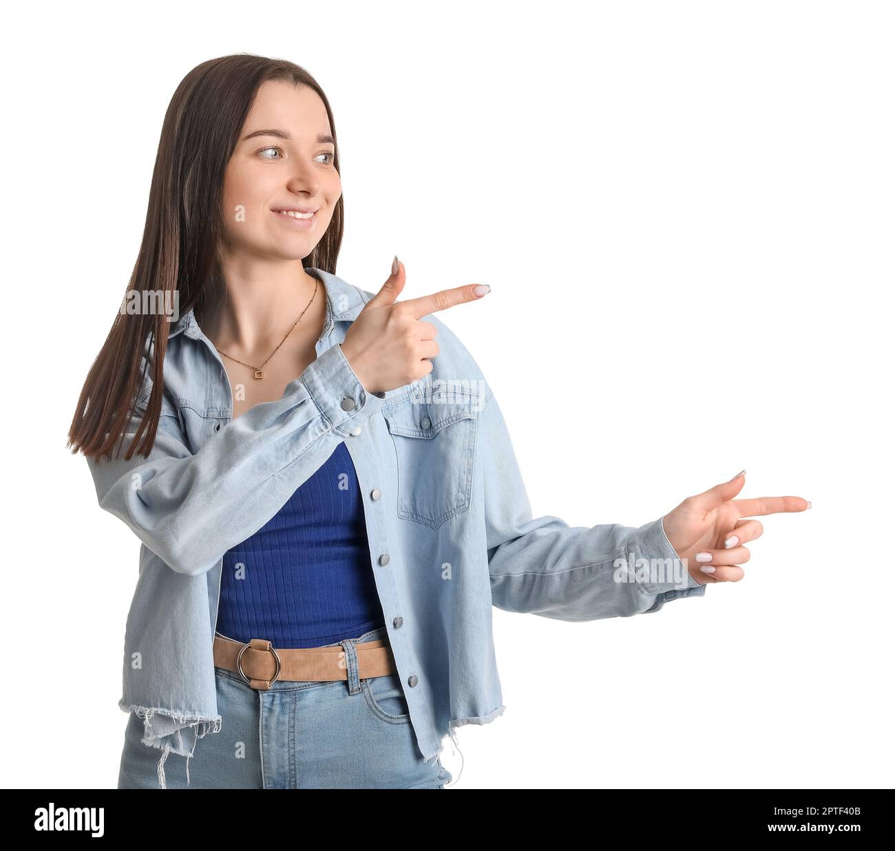 Young woman in shirt pointing at something on white background Stock ...