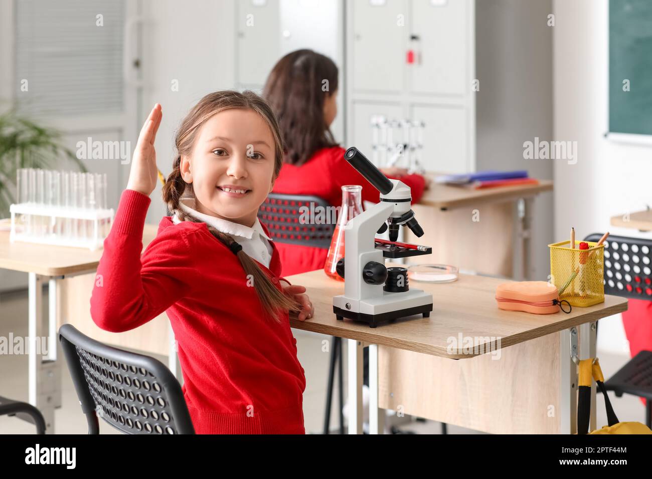 Little girl with microscope having Chemistry lesson in science ...