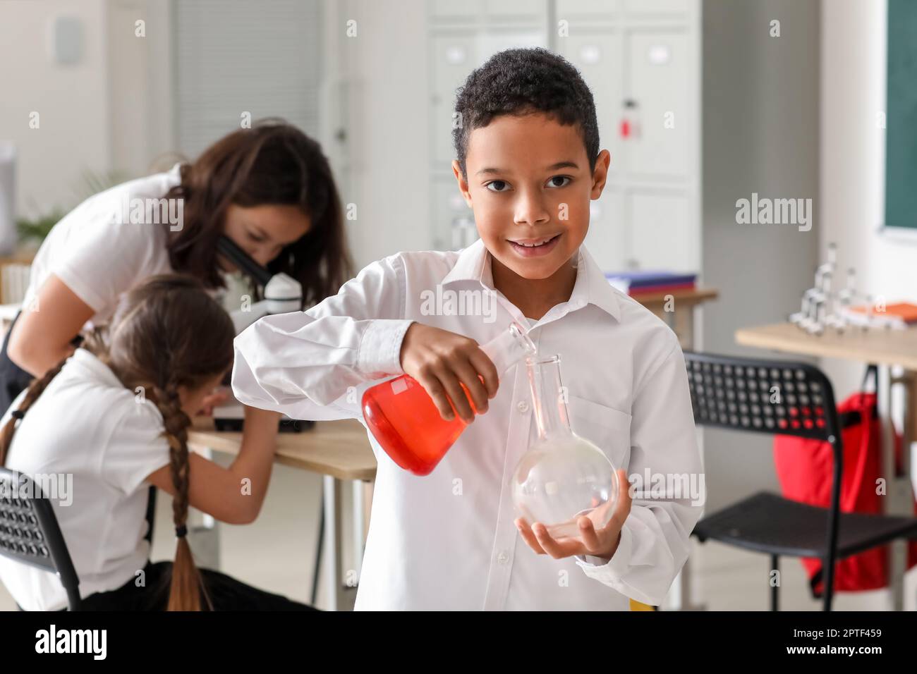African-American little boy with flasks in science classroom Stock ...