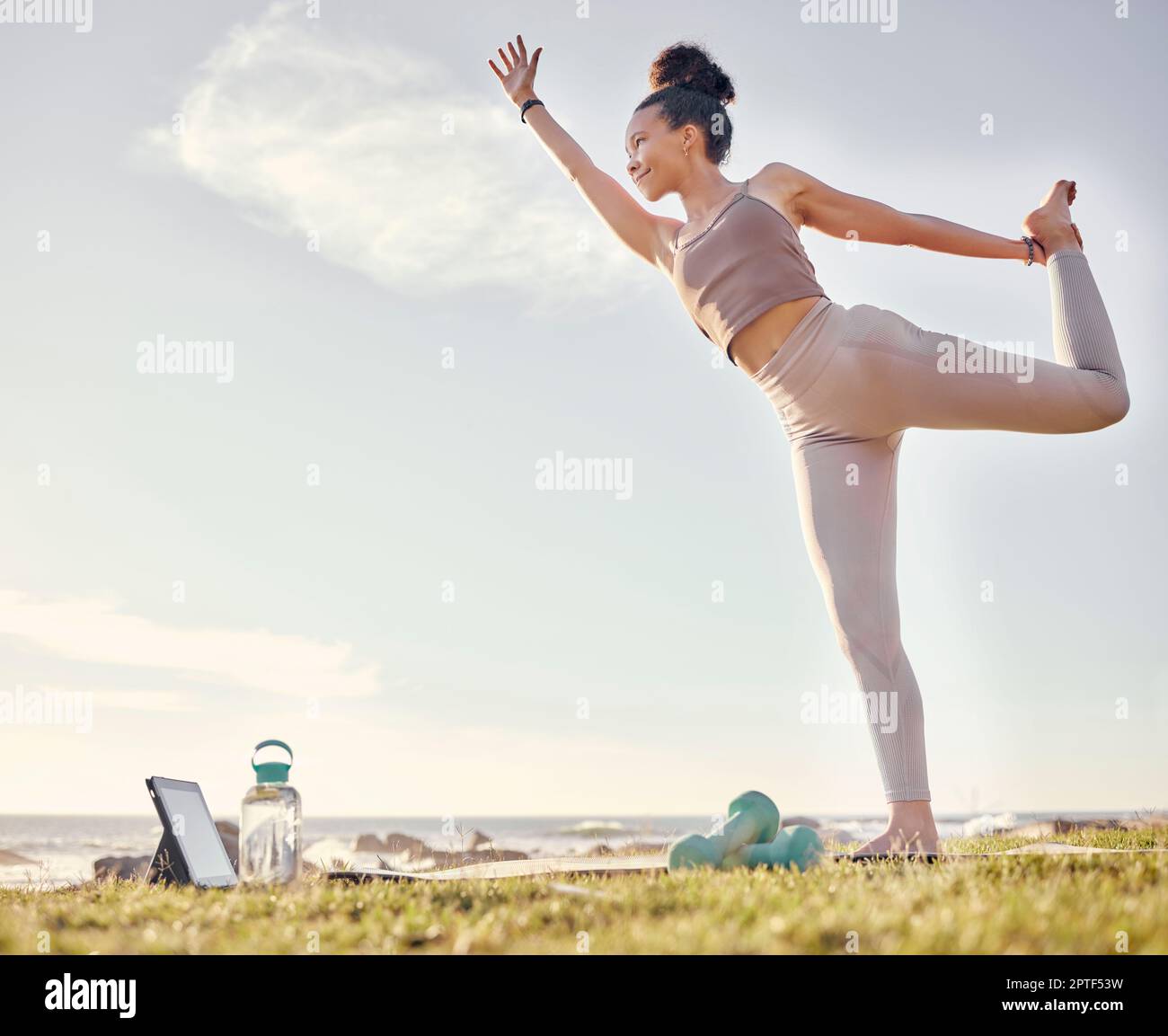 Yoga, tablet and nature with a woman athlete by the ocean for inner ...