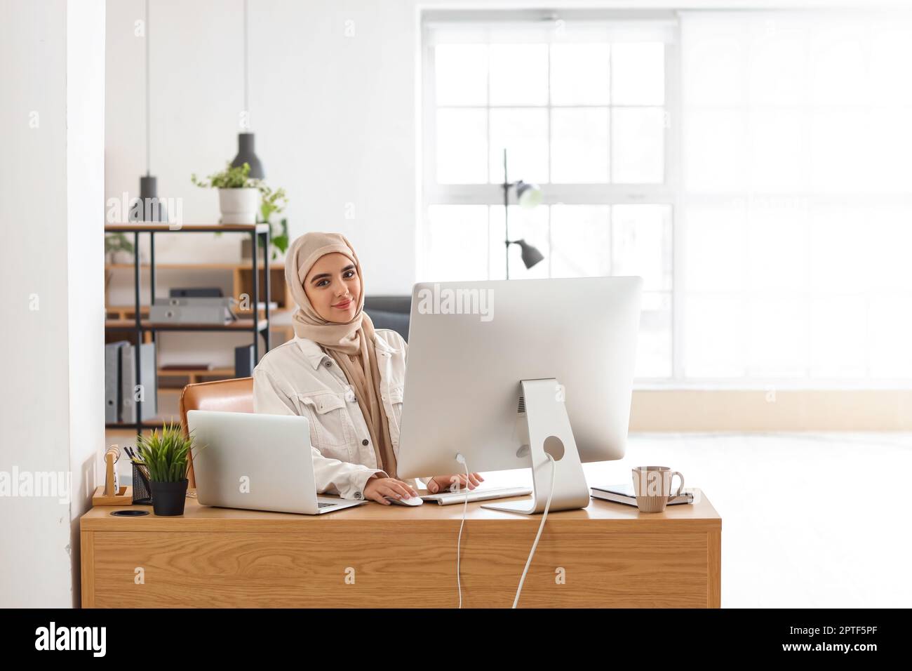 Arabian female programmer working in office Stock Photo - Alamy