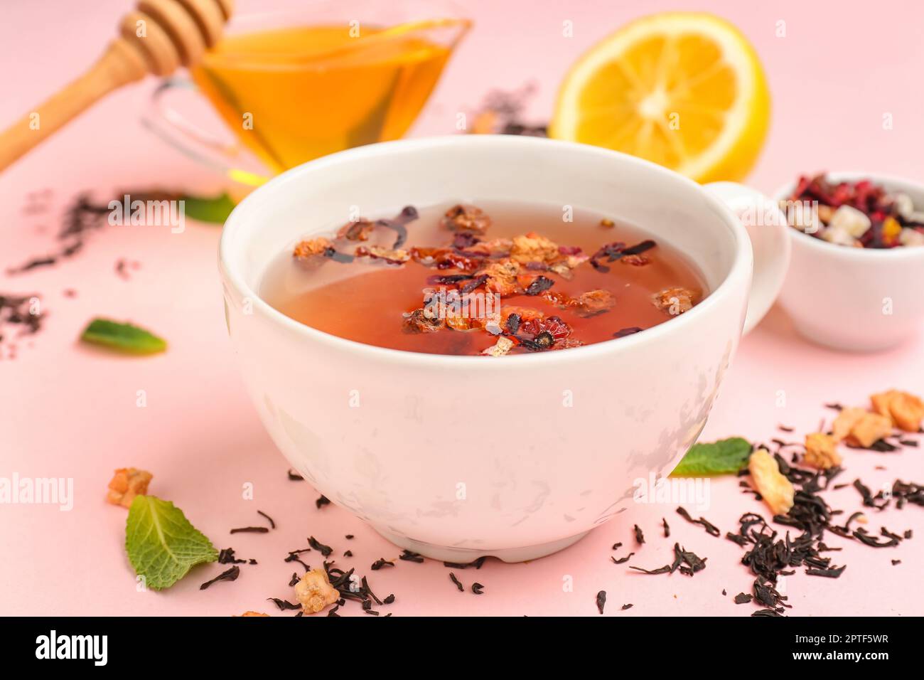Cup of fruit tea on pink background, closeup Stock Photo - Alamy