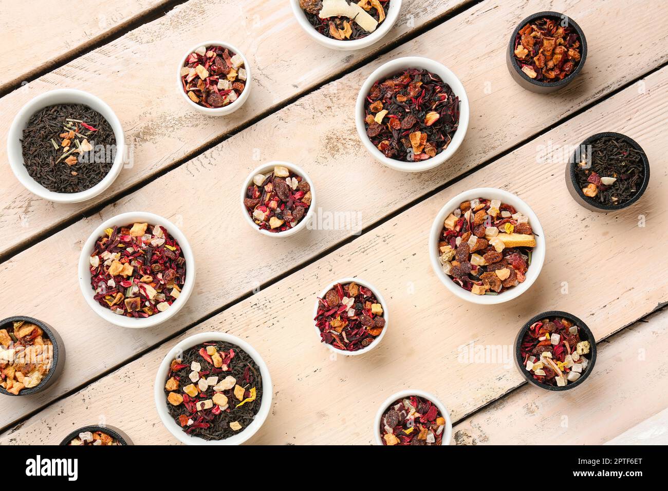 Assortment with different types of dried fruit tea on white wooden ...