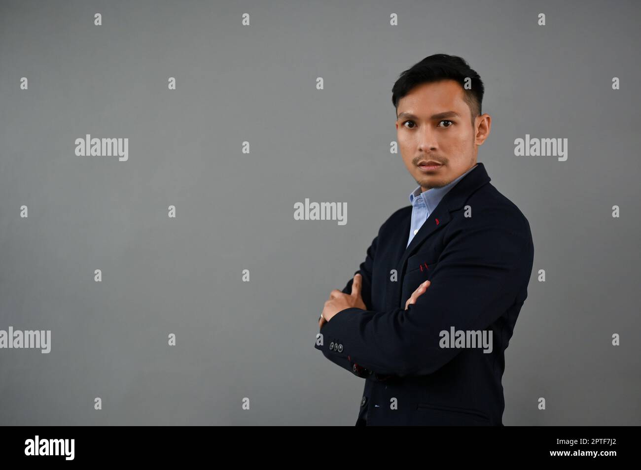 Serious and focused millennial Asian businessman or male CEO in a ...