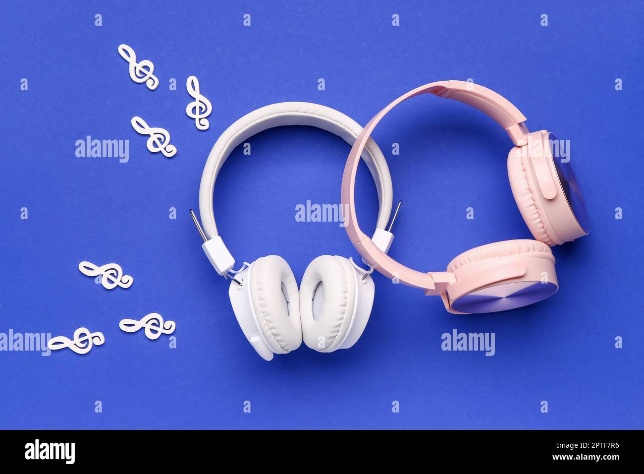 Modern headphones and music notes on blue background Stock Photo - Alamy